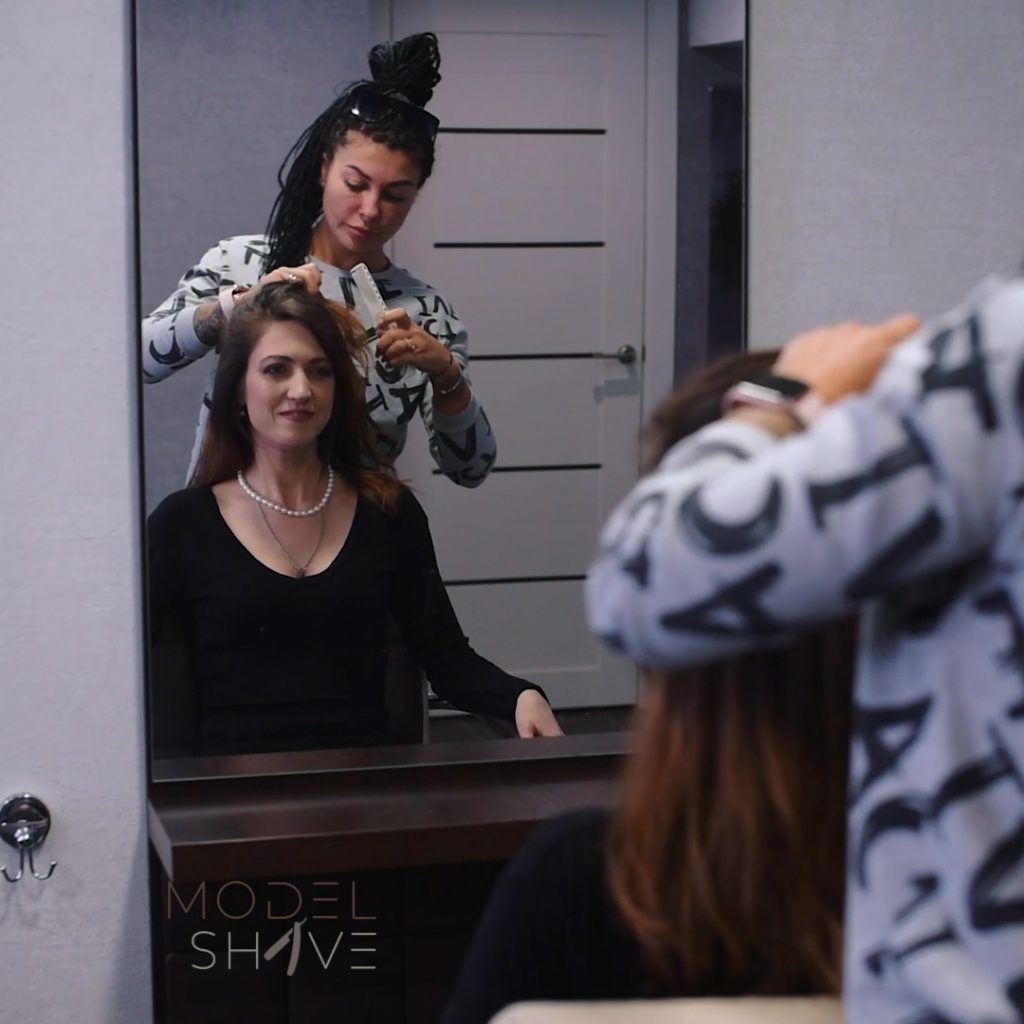Woman at the barbershop to make a smooth shiny headshave. - Model Shave