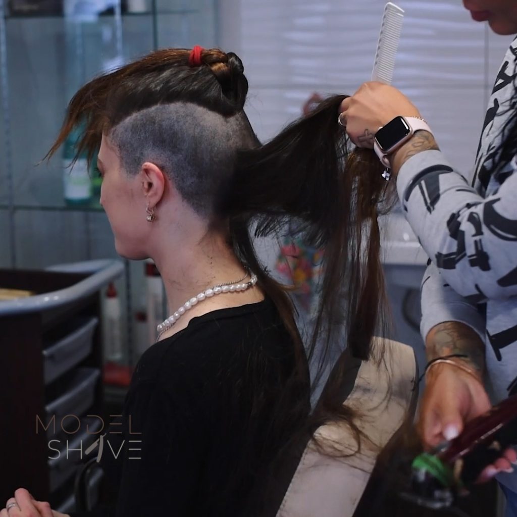 Woman at the barbershop to make a smooth shiny headshave. - Model Shave