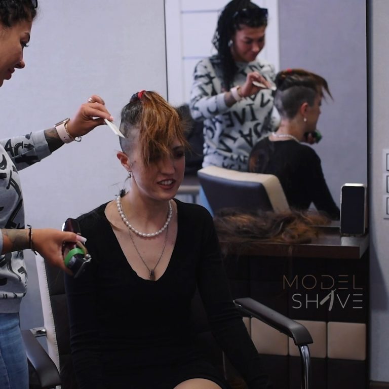 Woman at the barbershop to make a smooth shiny headshave. - Model Shave