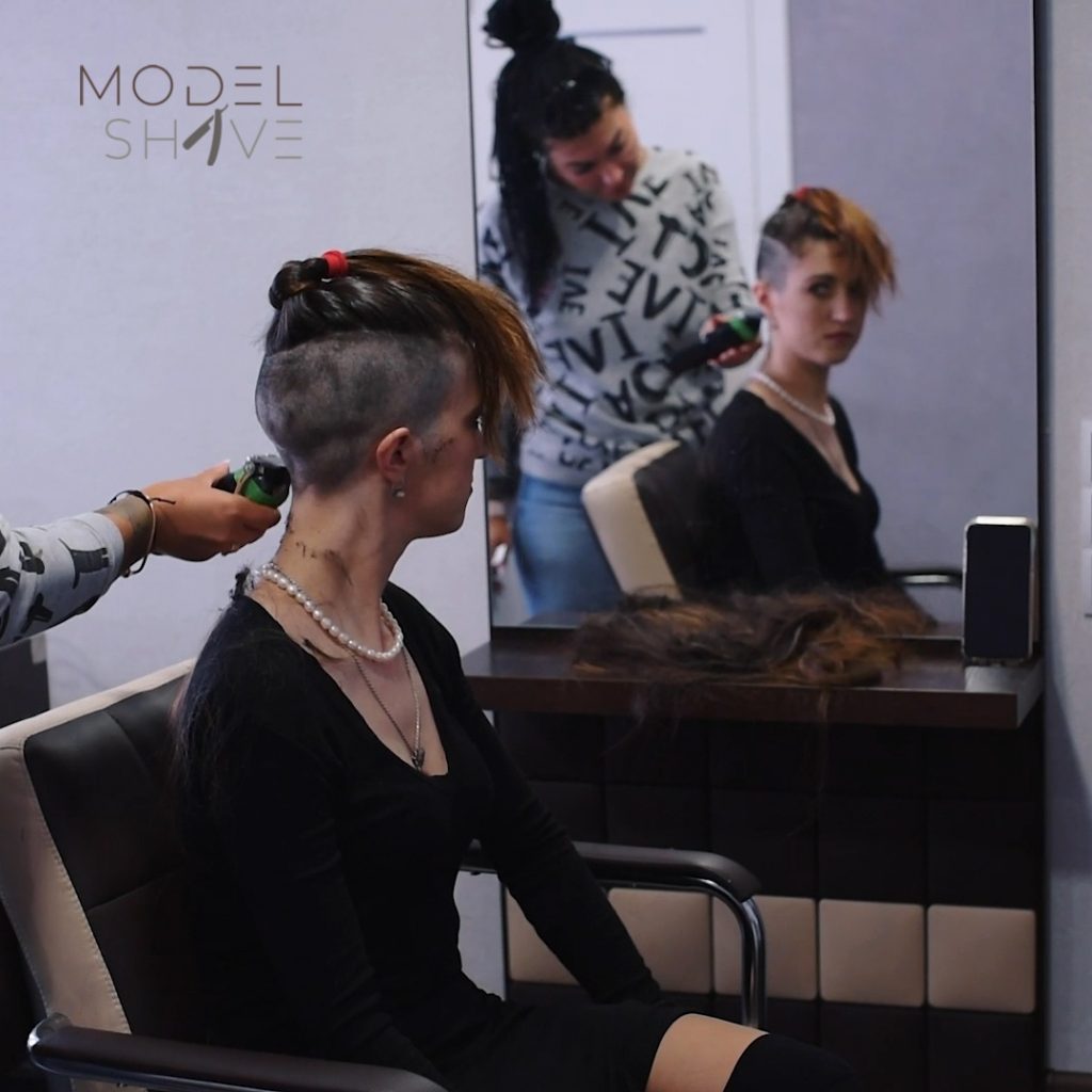 Woman at the barbershop to make a smooth shiny headshave. - Model Shave