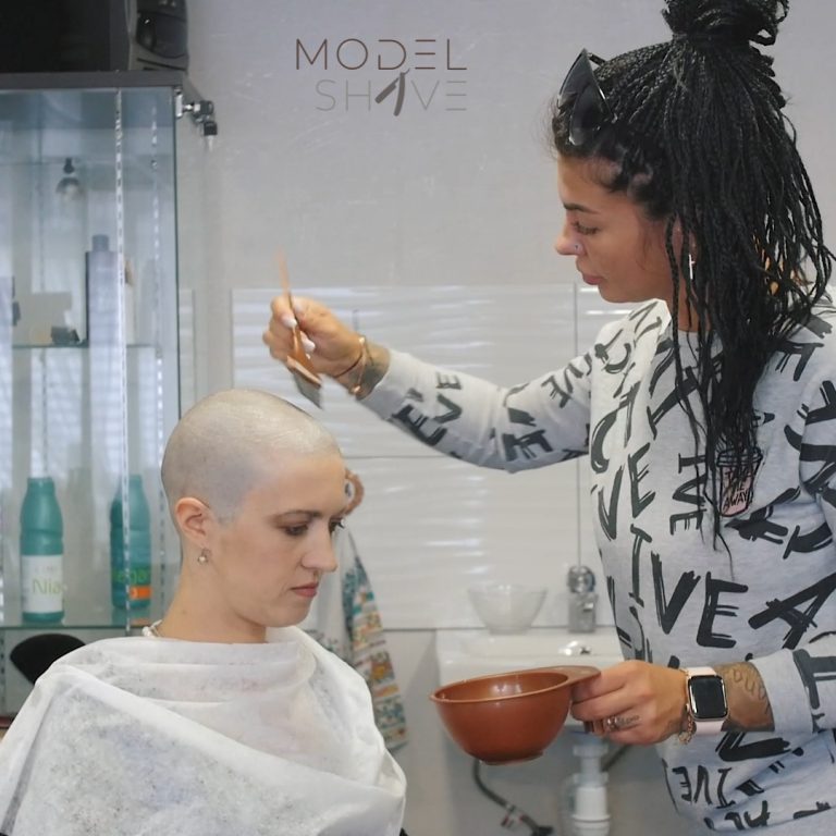 Woman at the barbershop to make a smooth shiny headshave. - Model Shave