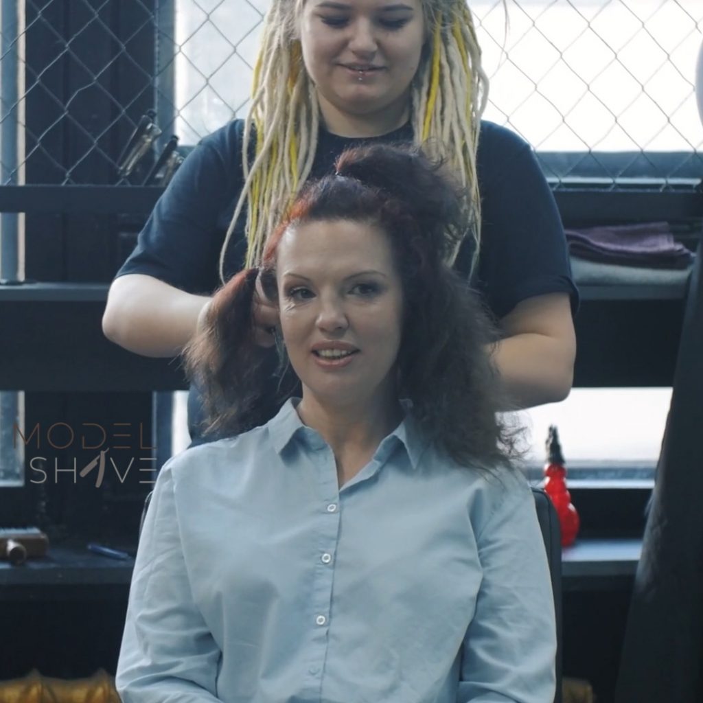 Lady does a full head shave in a classic barbershop. - Model Shave